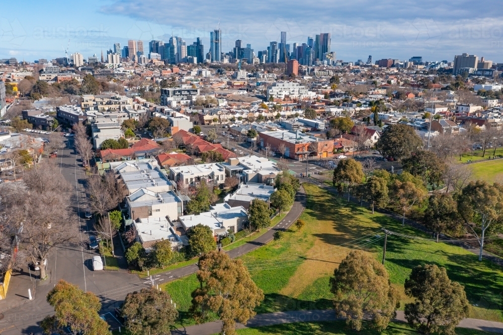 Image of Aerial view of housing around a suburban park with a city ...