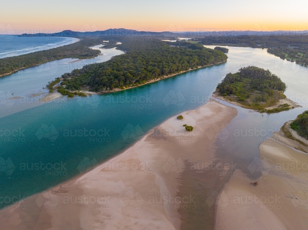 Image of Aerial view of islands and tidal sand flats in a river flowing ...