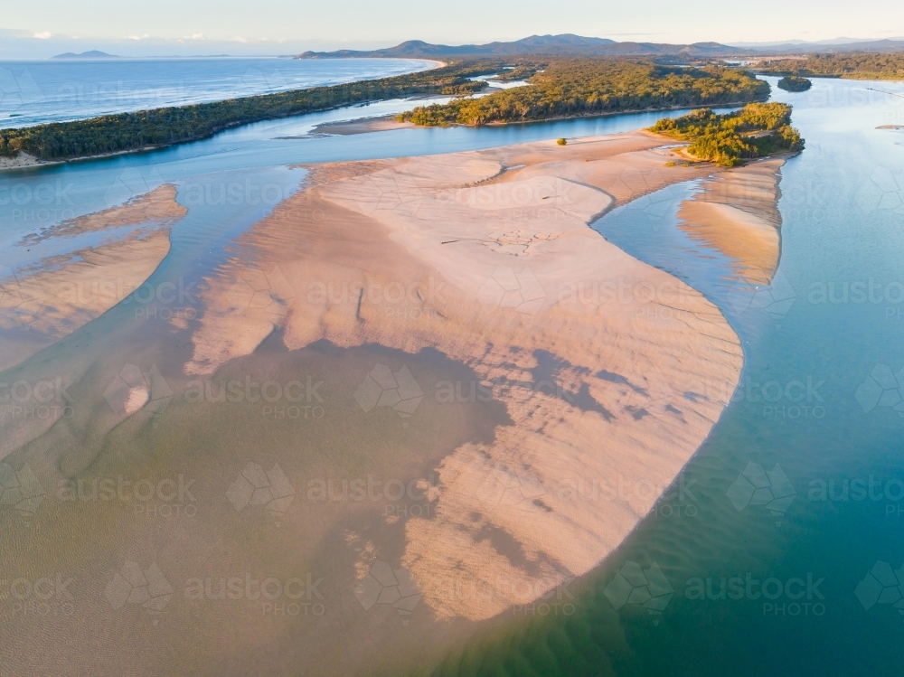 Image of Aerial view of islands and water pools on tidal sand flats in ...