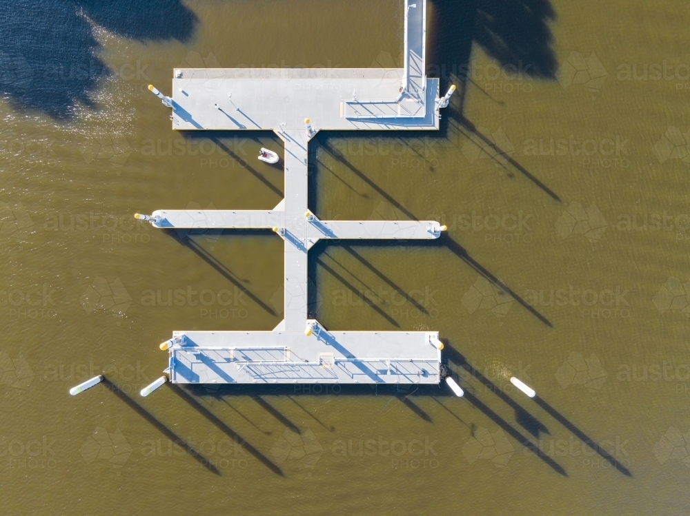 Image of Aerial view of jetty on a murky river with bollards casting ...