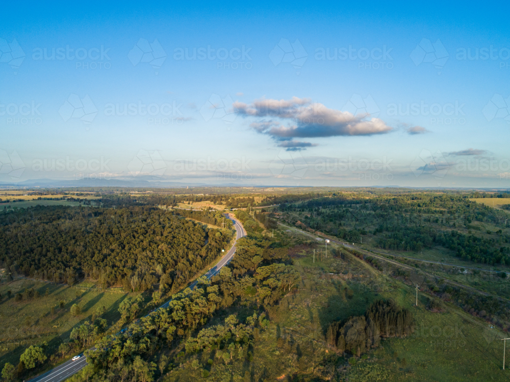 Image of Aerial view of landscape beside golden highway with power ...