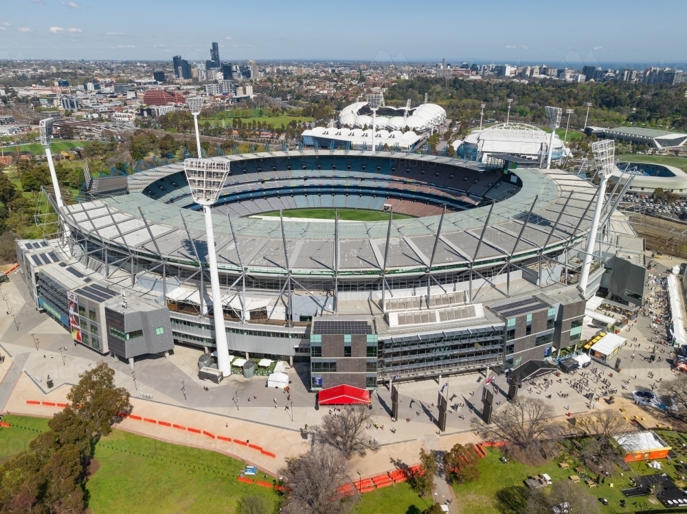 Image of Aerial view of large inner city sporting arena with tall light ...