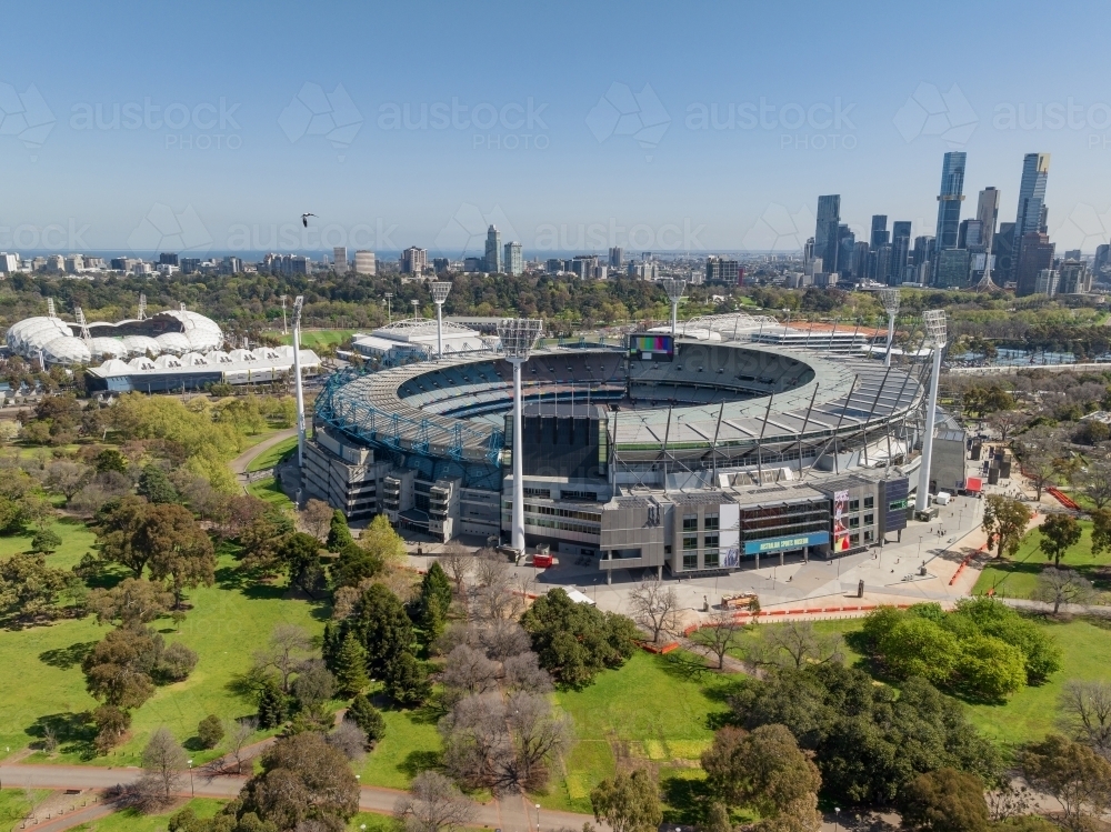 Image of Aerial view of large sporting arena surrounded by parkland ...