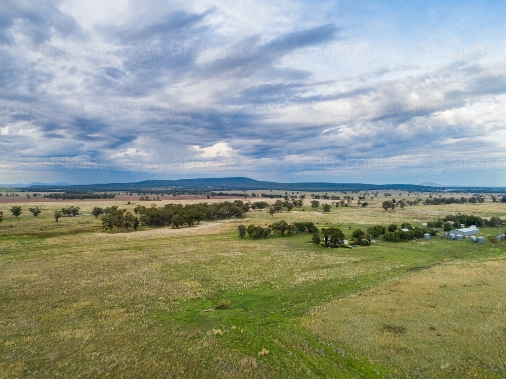 Image of Aerial view of lightly overcast sky with farm paddock and ...
