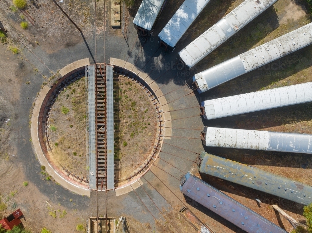 Image of Aerial view of long train carriages lined up around a railway ...
