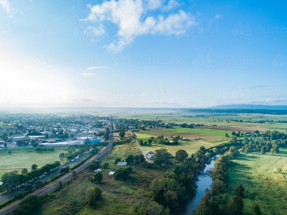 Image of Aerial view of morning light over railway line and river with ...