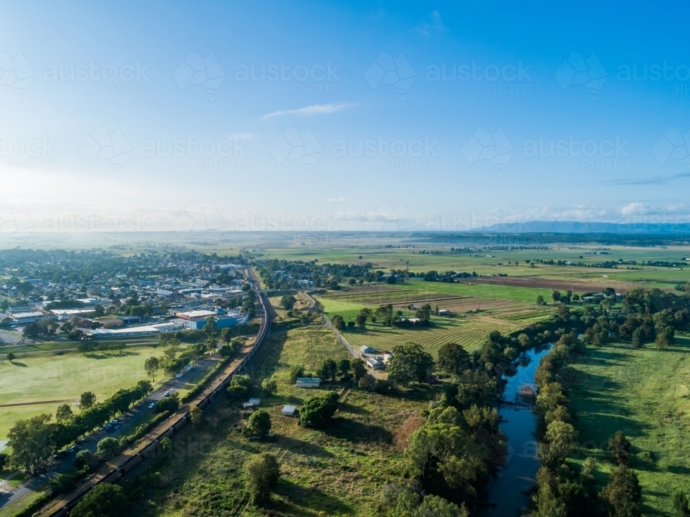 Image of Aerial view of morning light over railway line and river with ...