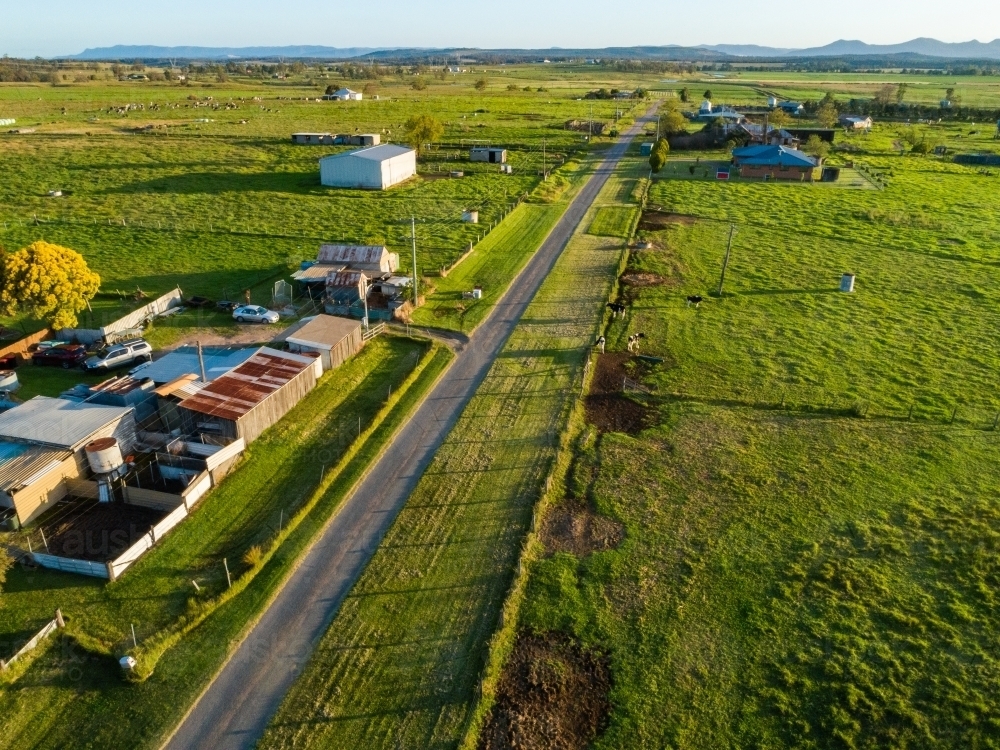 Image of Aerial view of narrow country road and lush green farmland ...