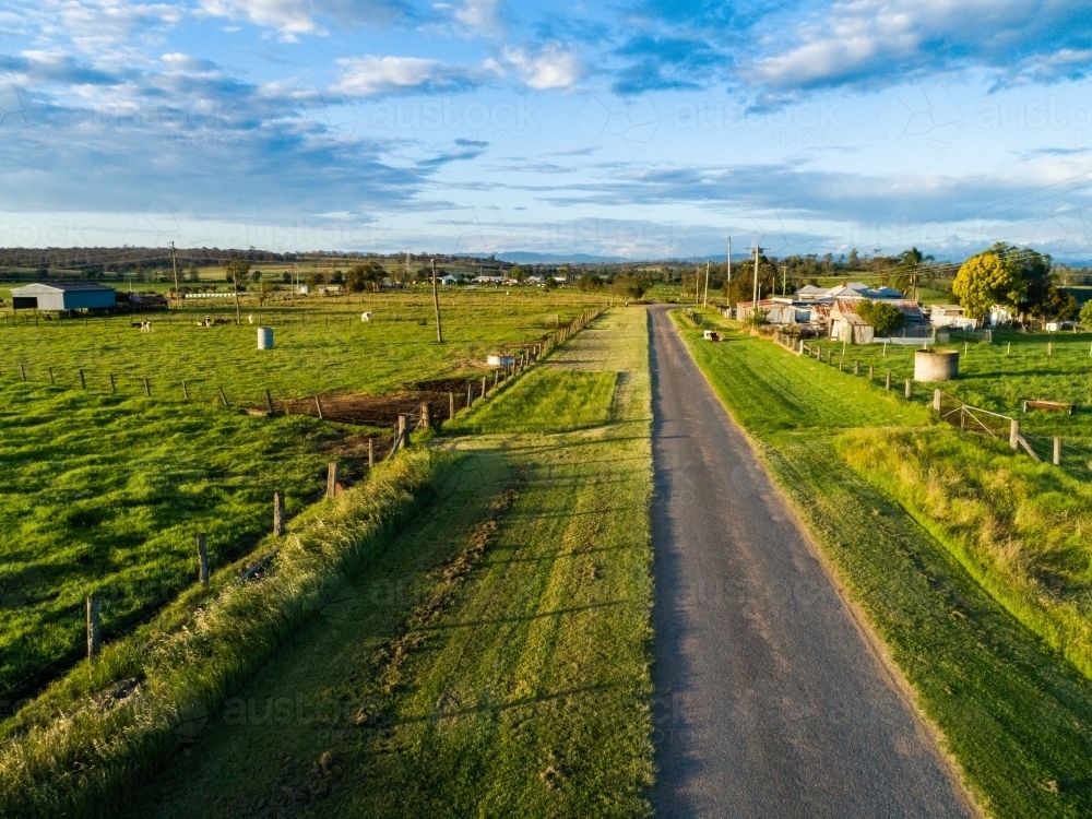 Image of Aerial view of narrow country road and lush green farmland ...