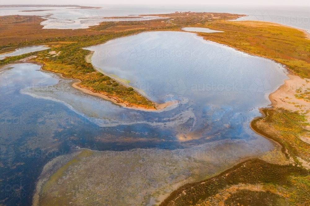 Image of Aerial view of narrow peninsula in a coastal lagoon - Austockphoto