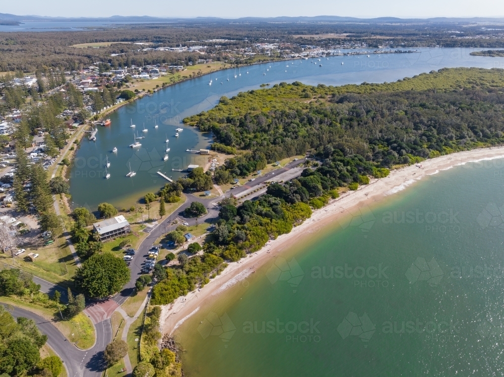 Image of Aerial view of narrow sandy beach in front of coastal ...