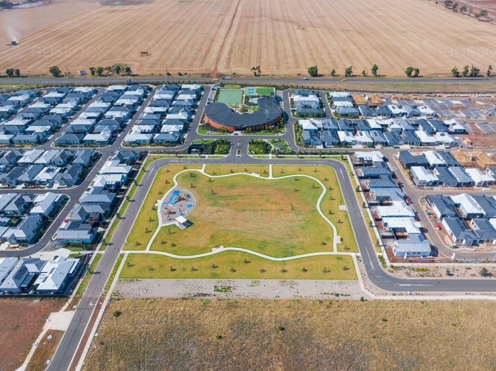 Image of Aerial view of new housing around a park in an urban ...