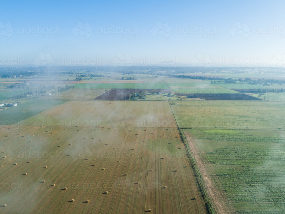 Image of Aerial view of paddocks of crops in flat agricultural farmland ...