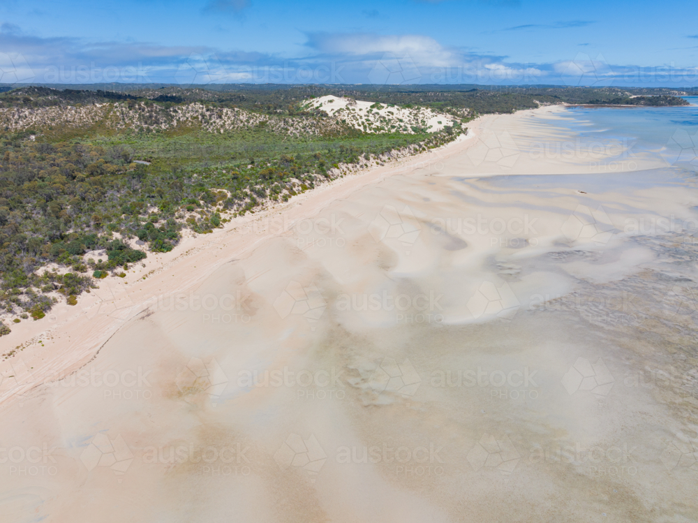 Image of Aerial view of patterns on tidal sand flats along a wide ...