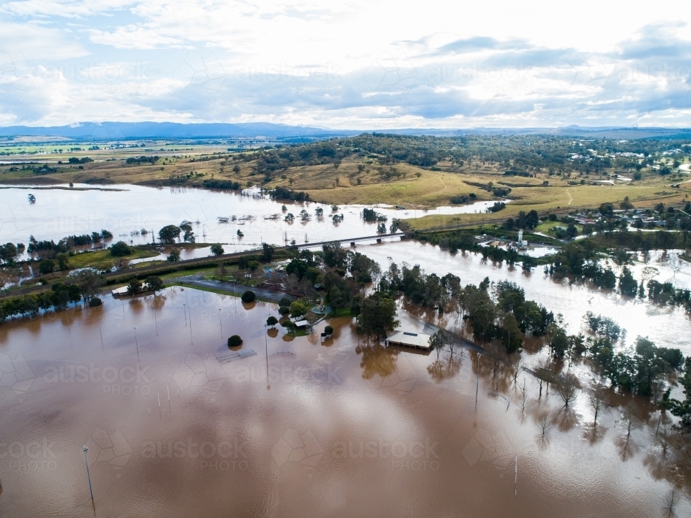 Image of Aerial view of playing field underwater during flood in ...