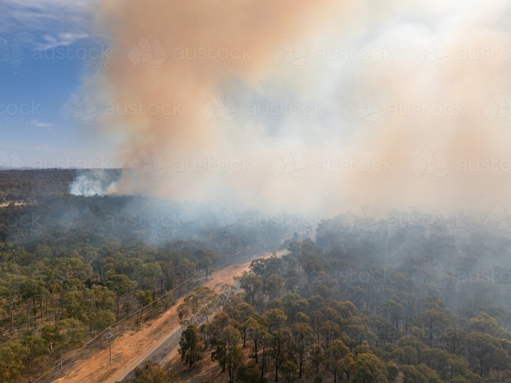 Image of Aerial view of plumes of brown bushfire smoke rising from ...
