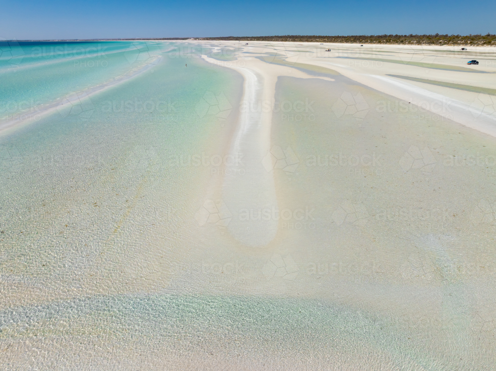 Image of Aerial view of pools of water on a pristine white sand beach ...
