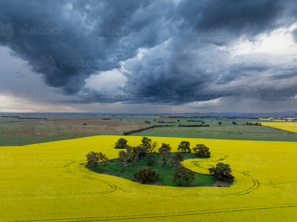Image of Aerial view of rain falling from dark dramatic clouds over a ...