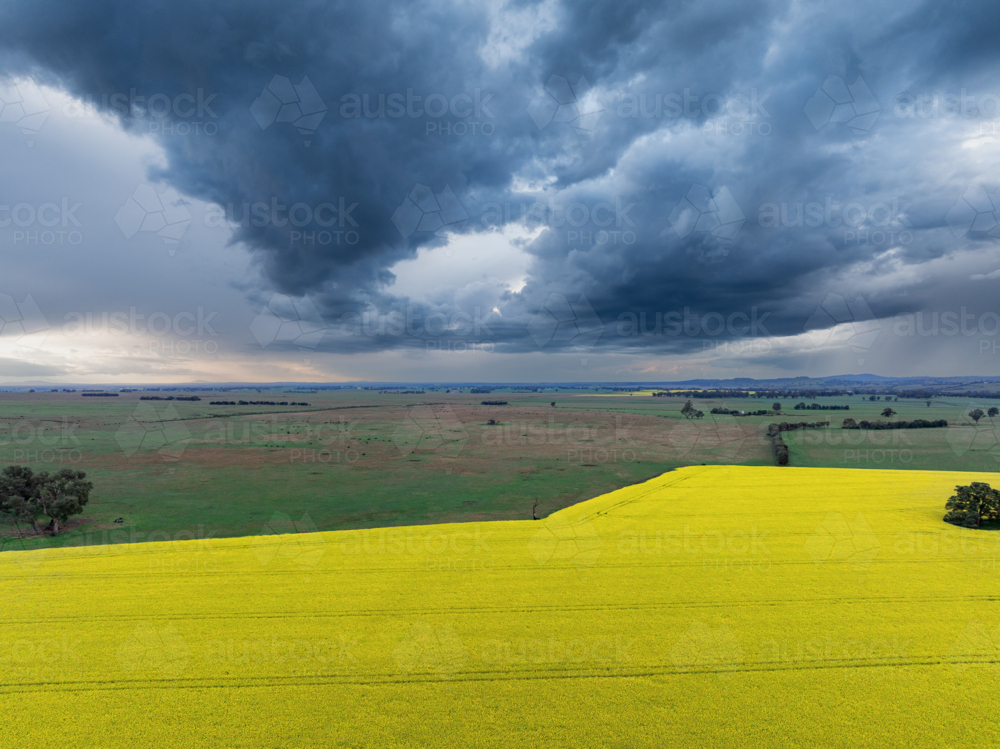 Image of Aerial view of rain falling from dark dramatic clouds over a ...