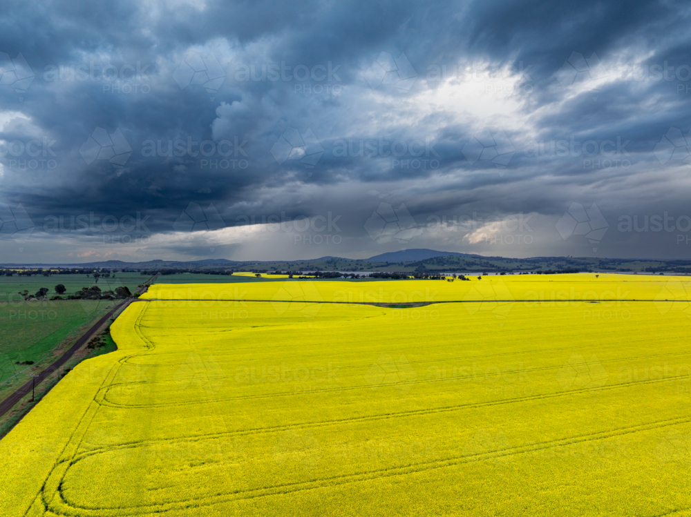 Image of Aerial view of rain falling from dark dramatic clouds over a ...