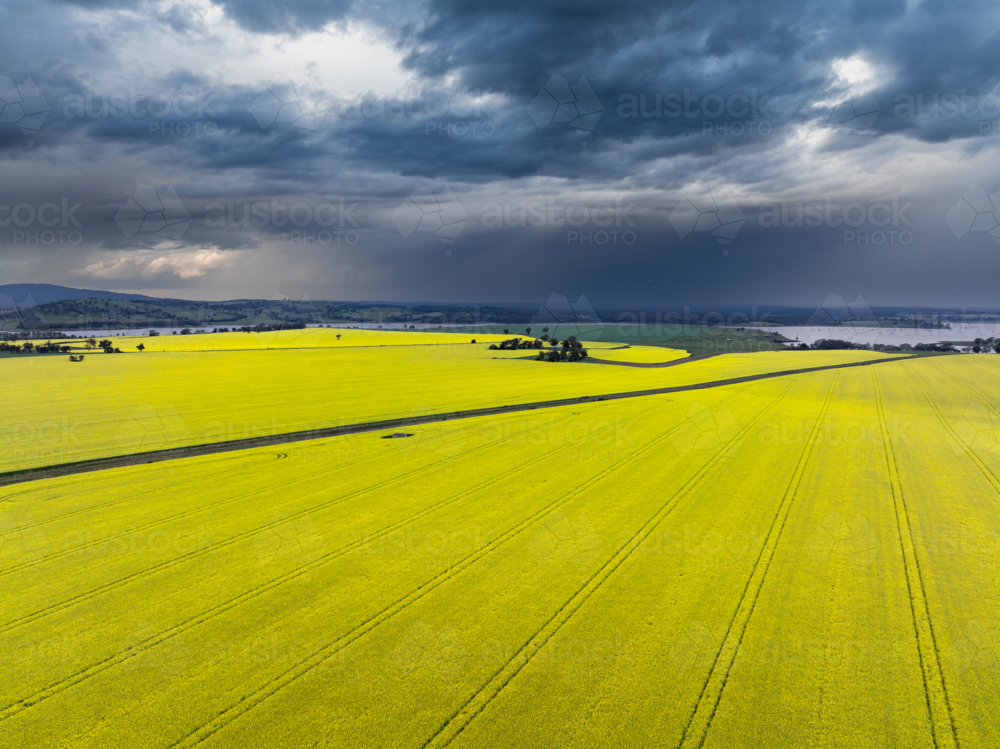 Image of Aerial view of rain falling from dark dramatic clouds over a ...