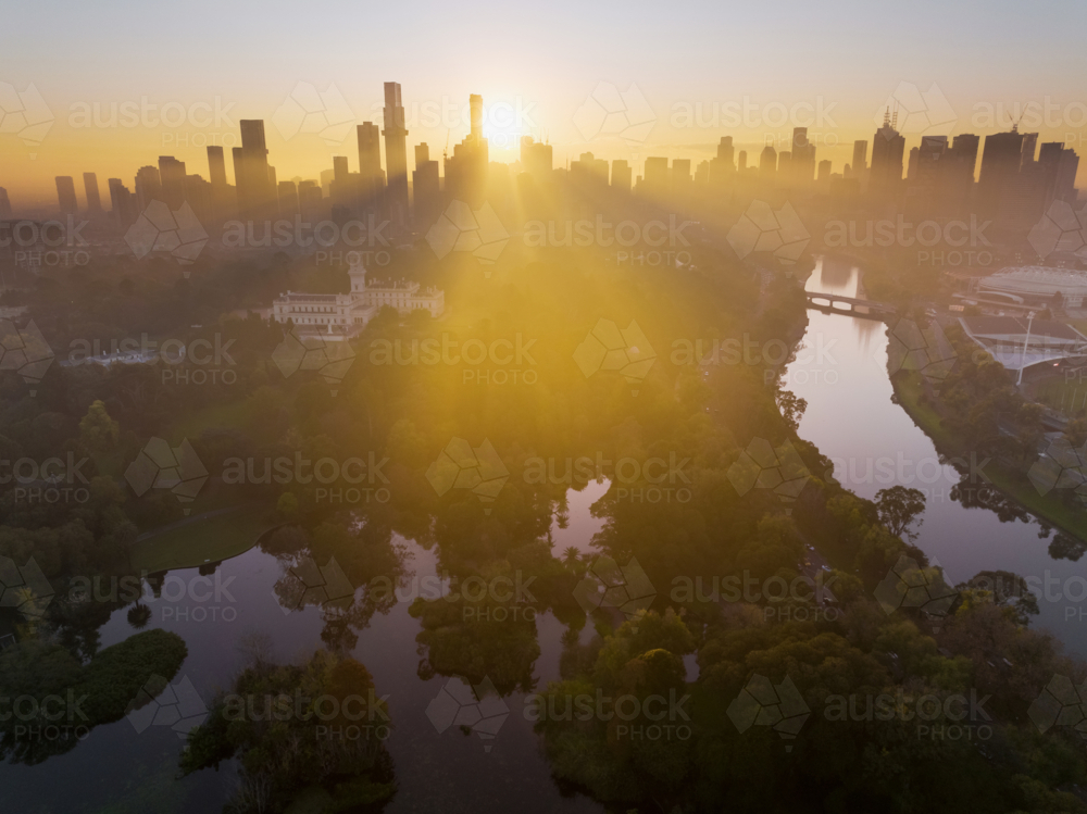 Image of Aerial view of rays of golden sunshine between high rise ...