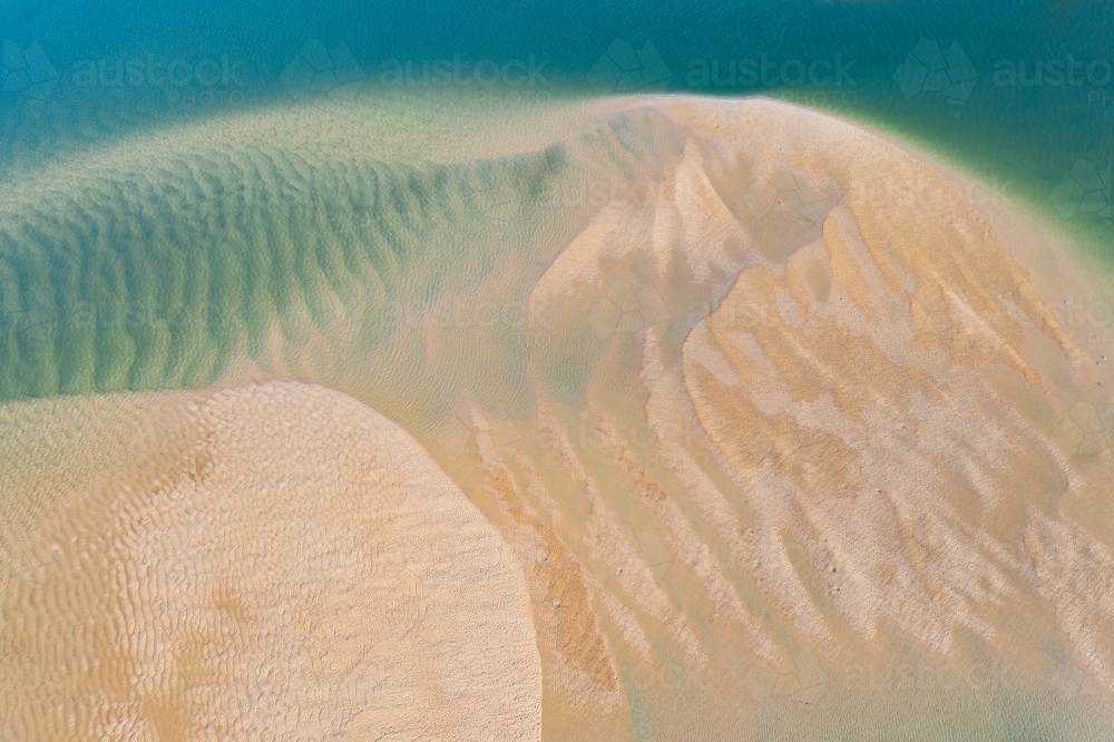 Image of Aerial view of ripples in tidal sand bars in blue sea water ...