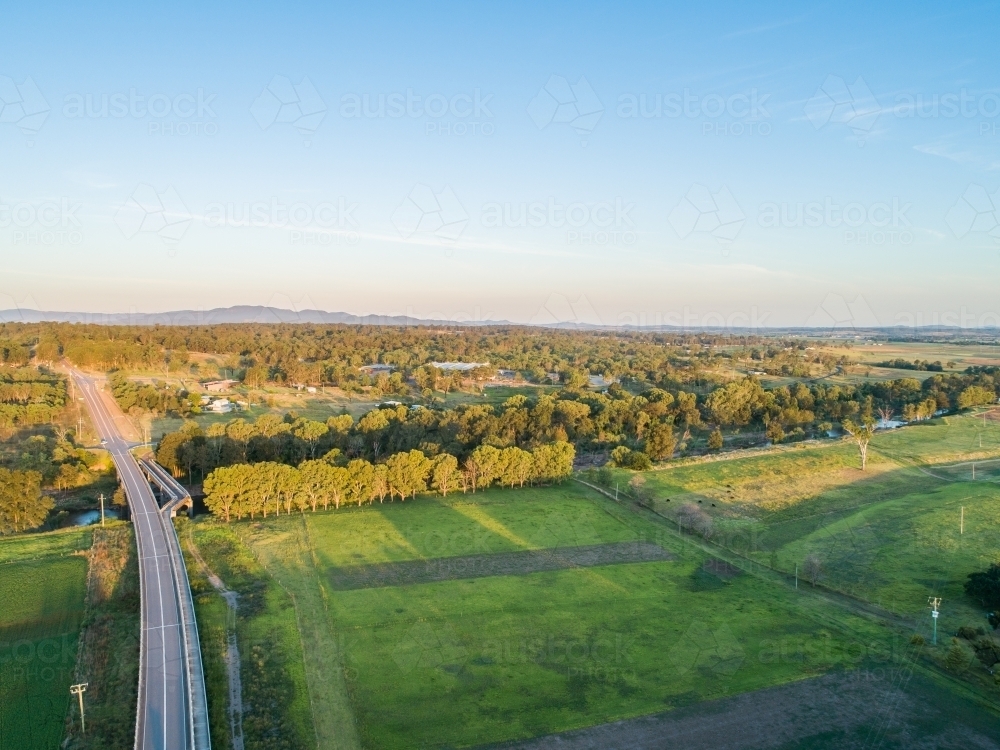 Image of Aerial view of road and bridge over floodplain farmland in ...