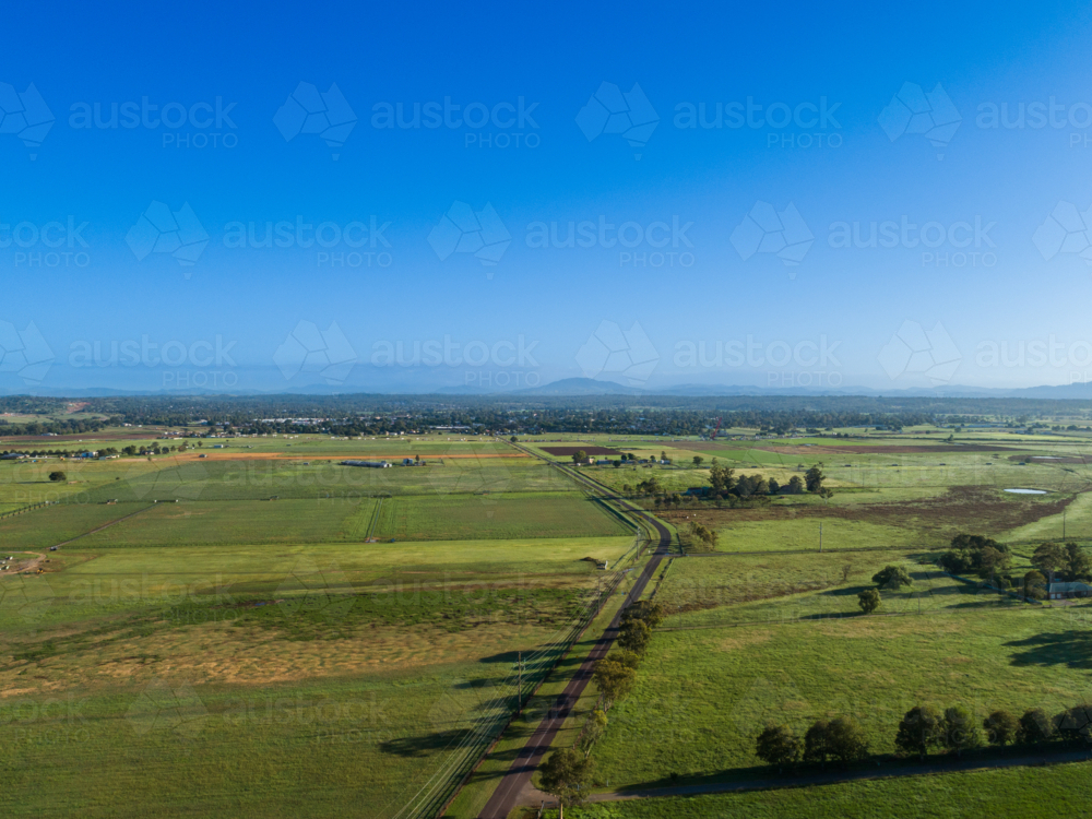 Image of Aerial view of road in farmland on bright sunlit summer ...