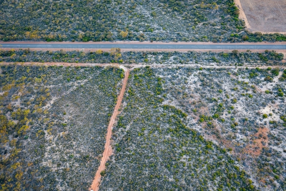 Image of aerial view of road through low scrub with bush tracks ...