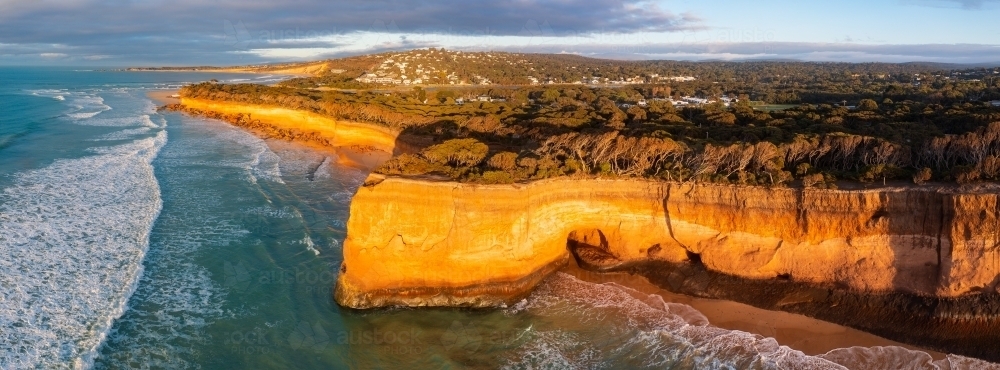 Image of Aerial view of rugged sea cliffs in golden morning sunshine ...