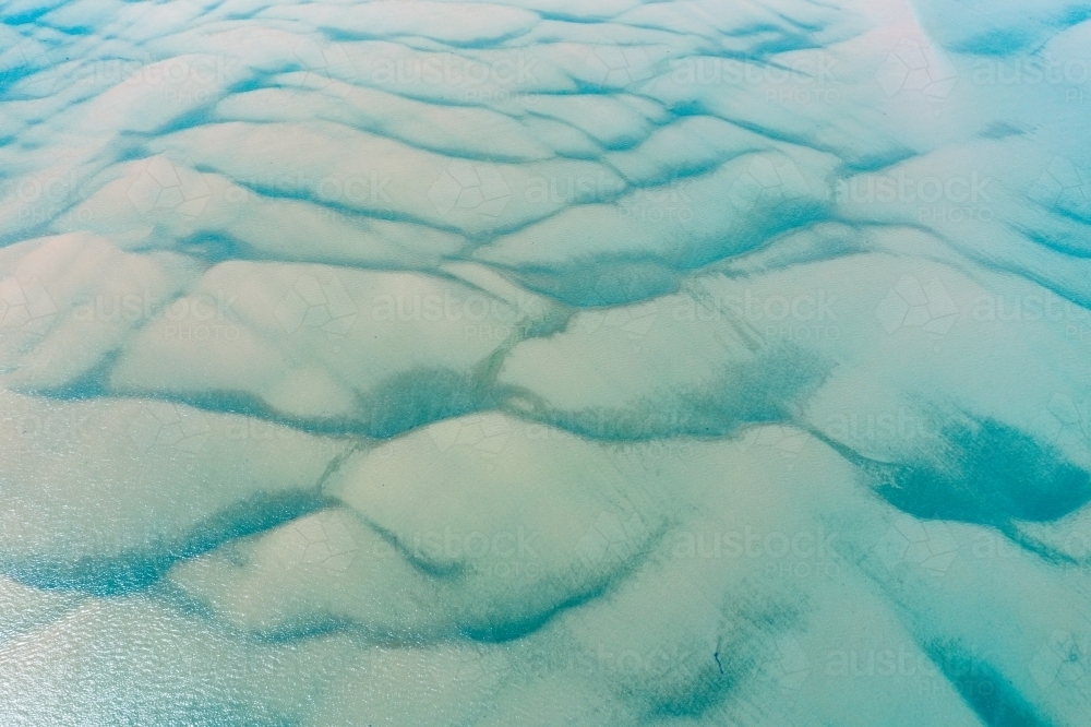 Image of Aerial view of sand patterns in a shallow sea water inlet ...