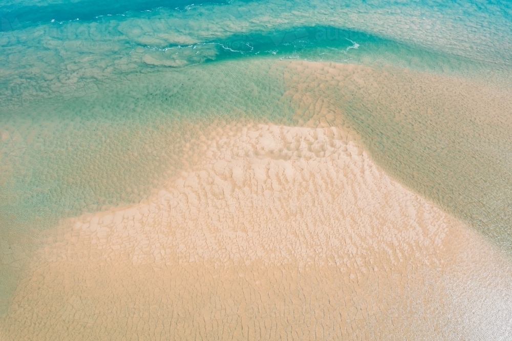 Image of Aerial view of sand patterns in a shallow sea water inlet ...