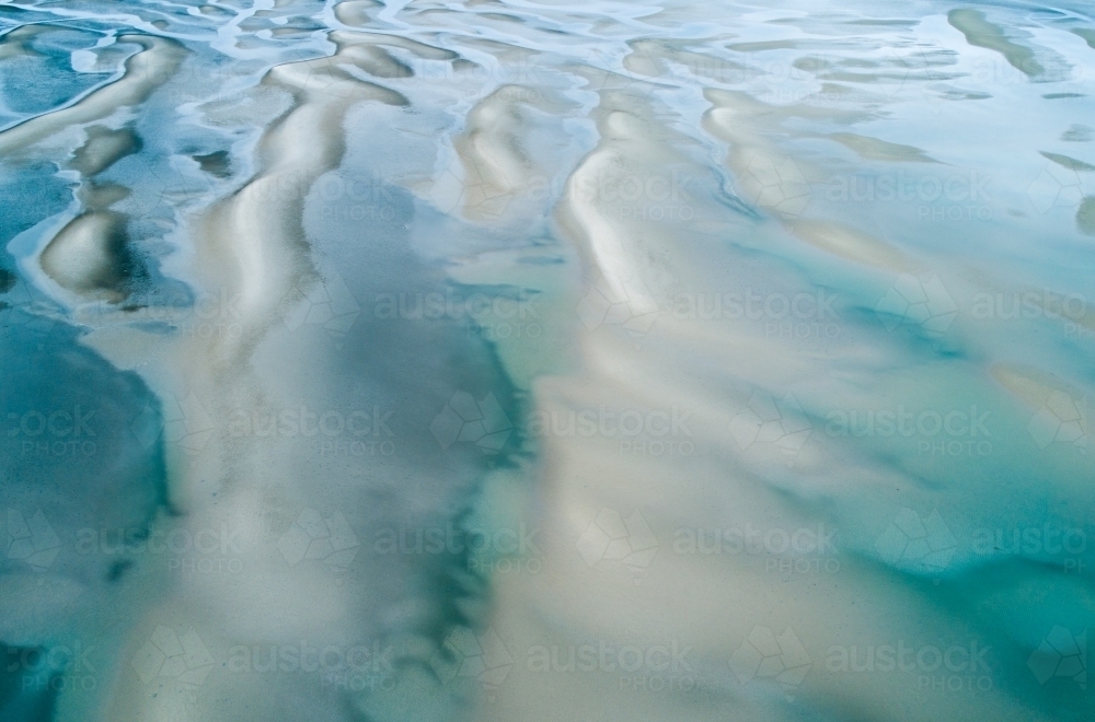 Image of Aerial view of sandbar patterns in shallow blue water ...