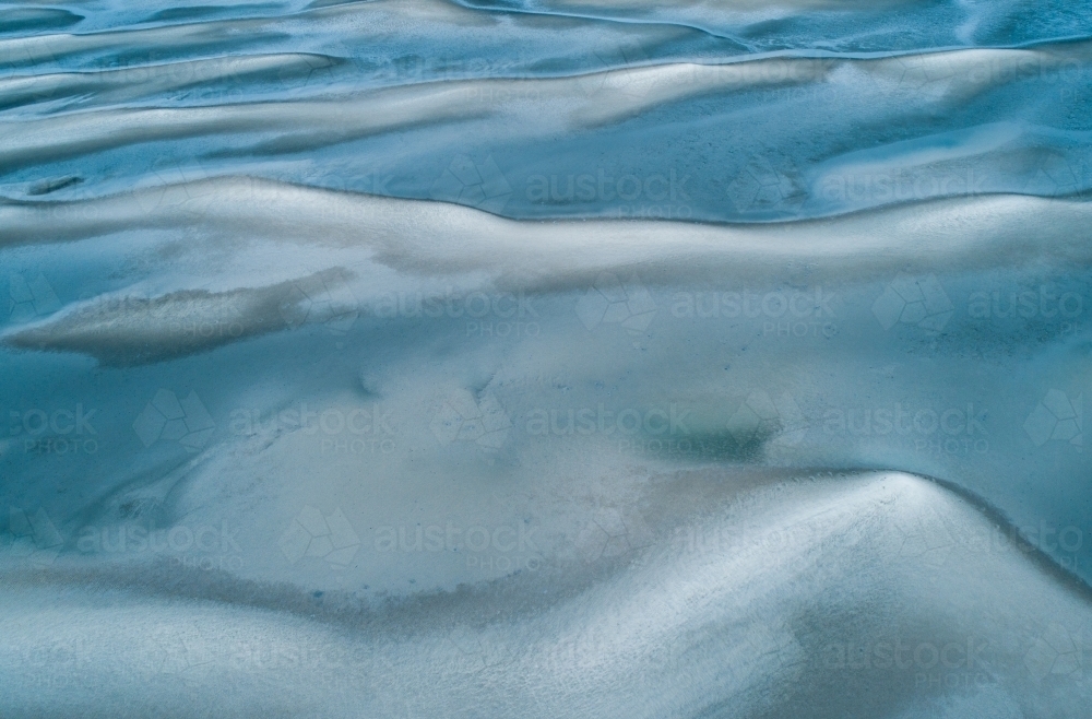 Image of Aerial view of sandbar patterns in shallow blue water ...