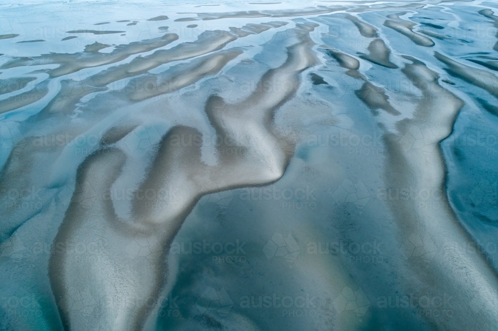 Image of Aerial view of sandbar patterns in shallow blue water ...