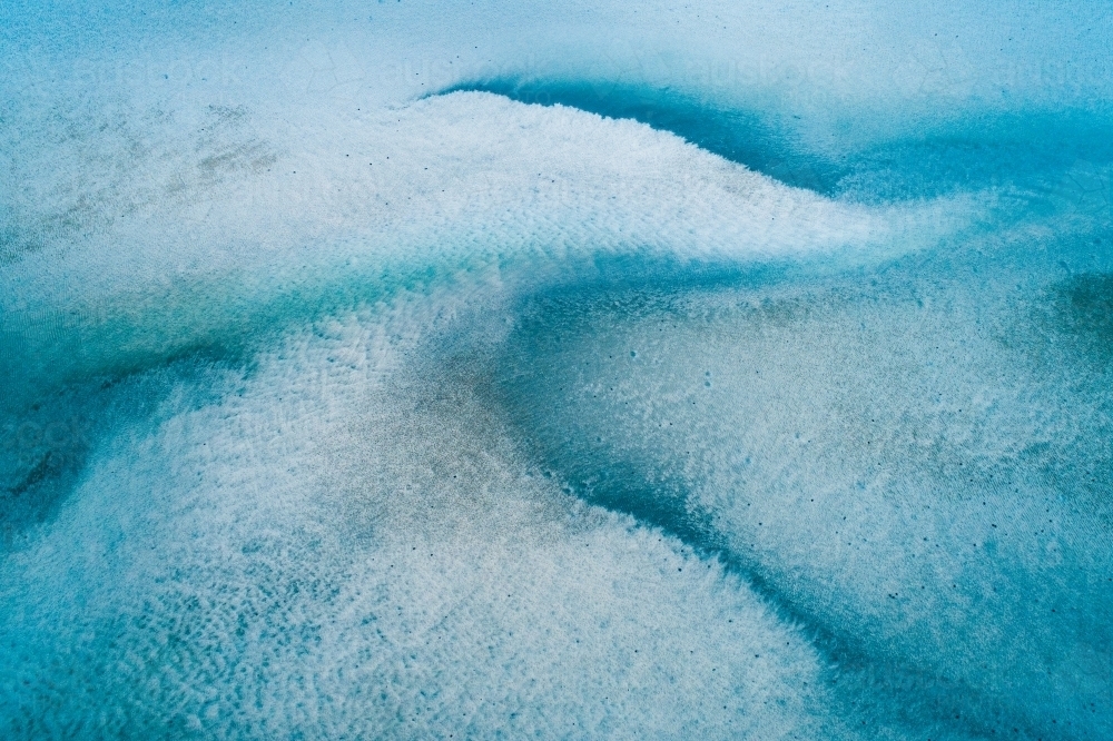 Image of Aerial view of sandbar patterns in shallow blue water ...