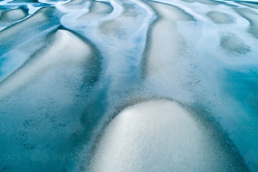 Image of Aerial view of sandbar patterns in shallow blue water ...