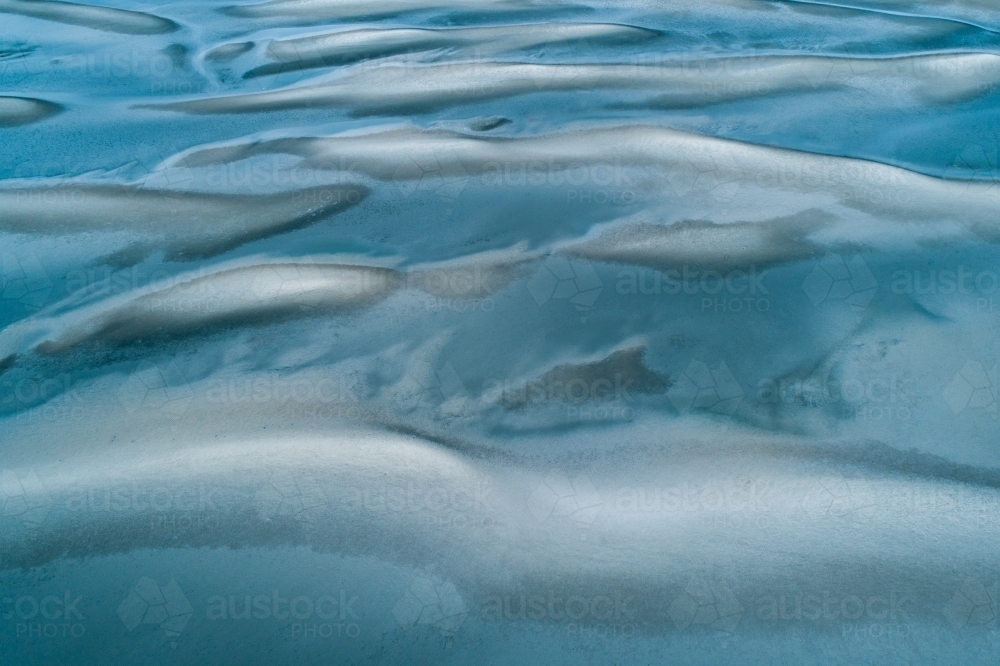 Image of Aerial view of sandbar patterns in shallow blue water ...