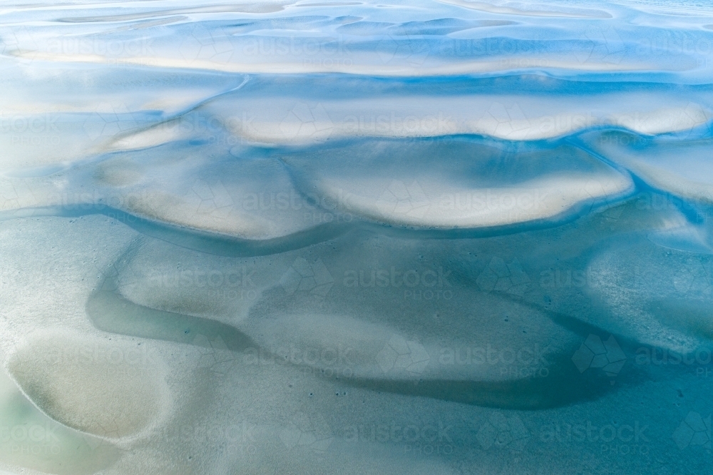 Image of Aerial view of sandbar patterns in shallow blue water ...