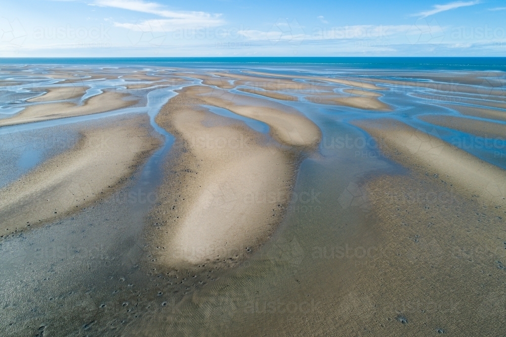 Image of Aerial view of sandbar patterns in shallow blue water ...