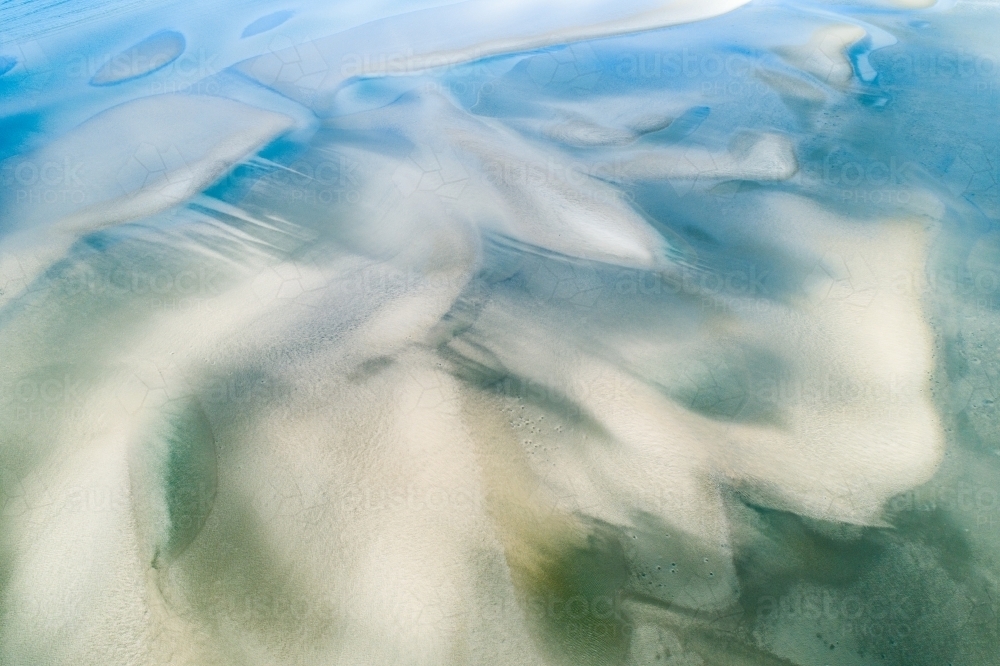 Image of Aerial view of sandbar patterns in shallow blue water ...