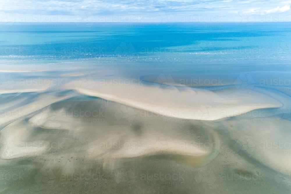 Image of Aerial view of sandbar patterns in shallow blue water ...