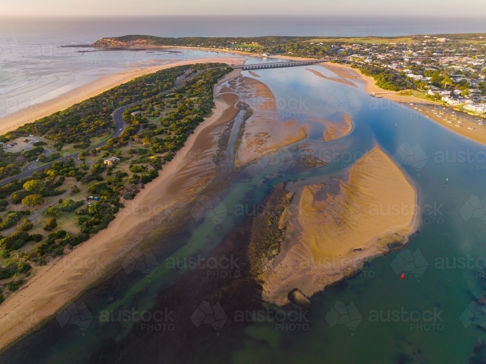 Image of Aerial view of sandbars in a coastal river flowing out to sea ...