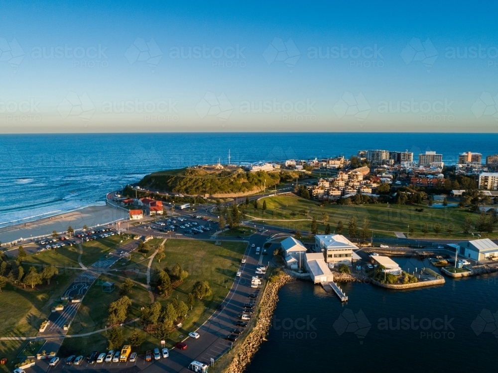 Image of Aerial view of seaside headland with Newcastle city and ...