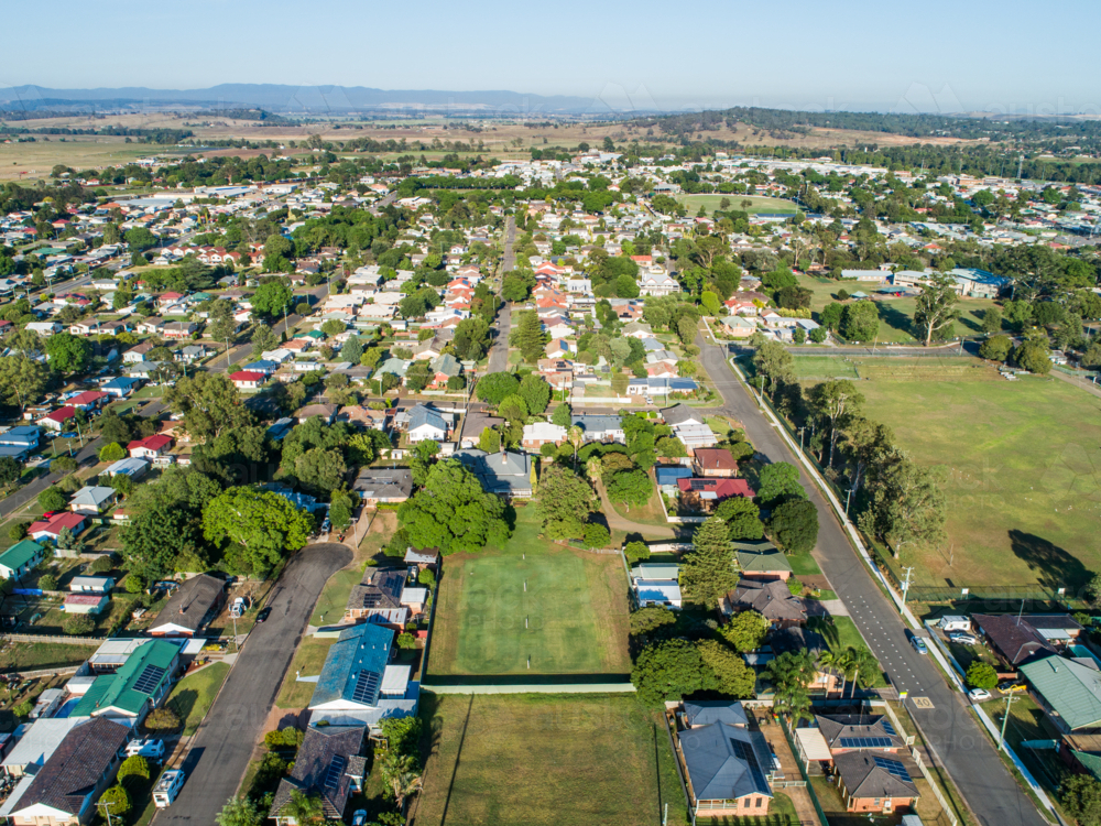 Image of Aerial view of Singleton streets and homes in town on sunlit ...