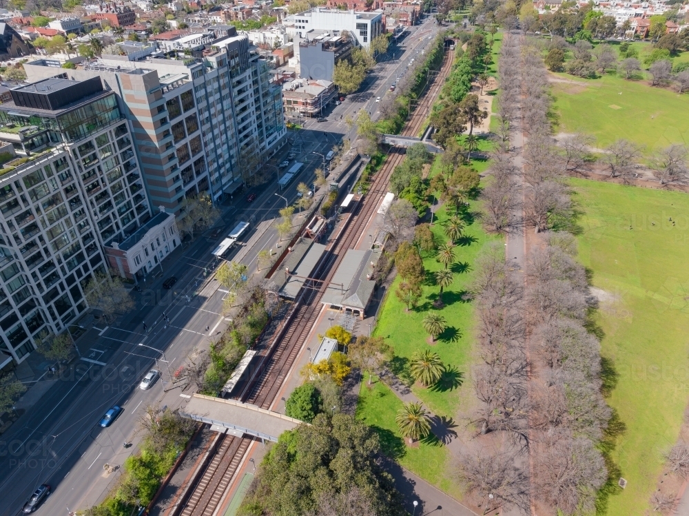 Image of Aerial view of suburban railway lines running alongside a road ...