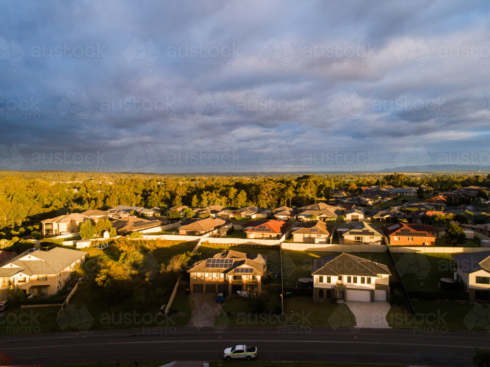 Image of Aerial view of sunset light on rooftops of newly developed ...