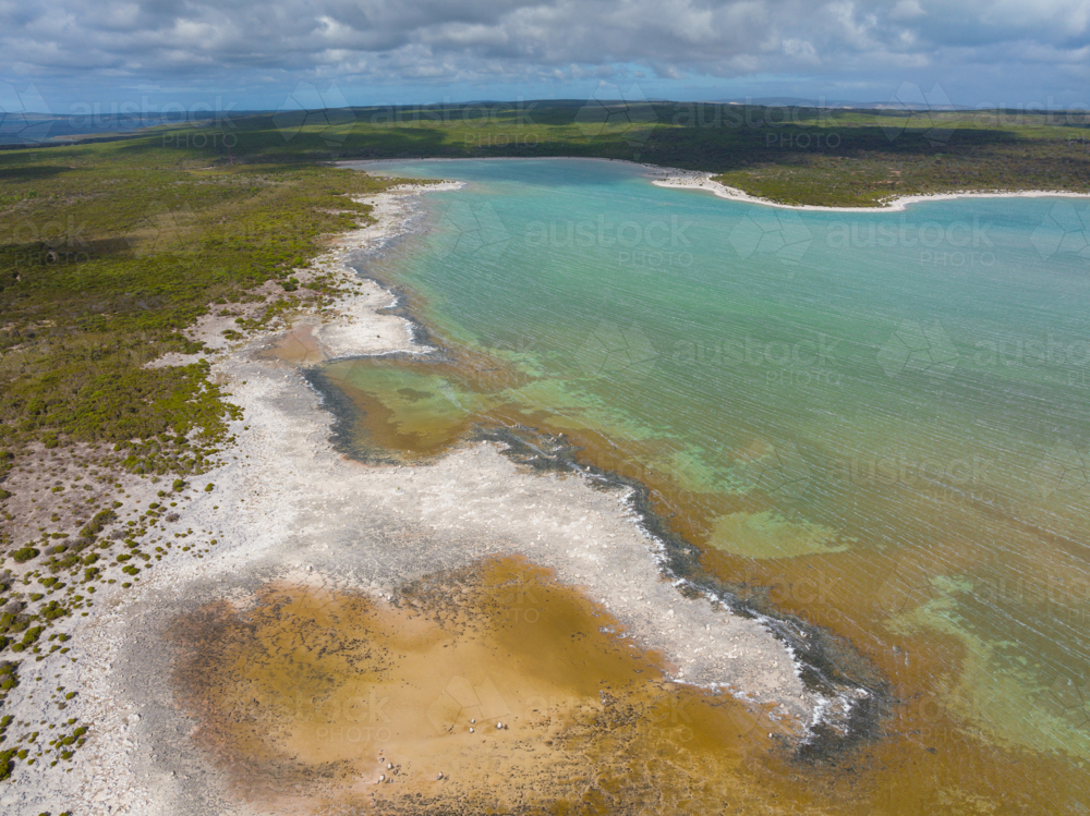 Image of Aerial view of the white crusty shoreline of a remote blue ...