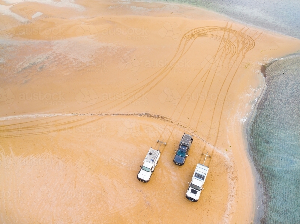 Image of Aerial view of three 4wd's and their tyre tracks on a sandbar ...